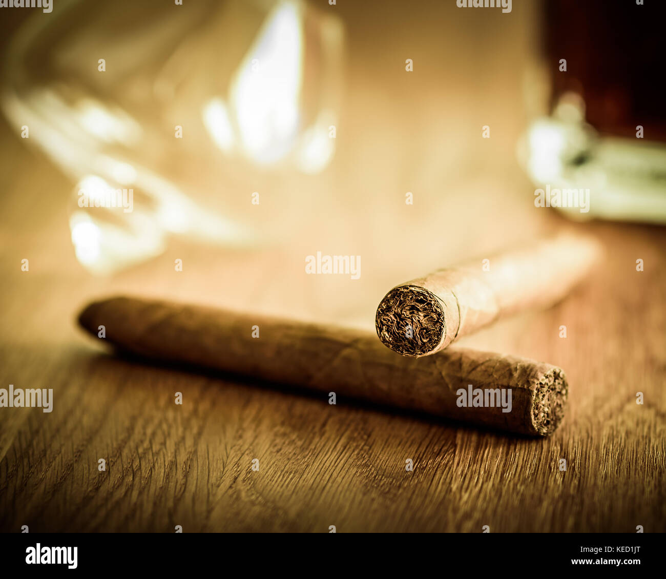 Two cigars, a bottle and an empty glass Stock Photo - Alamy
