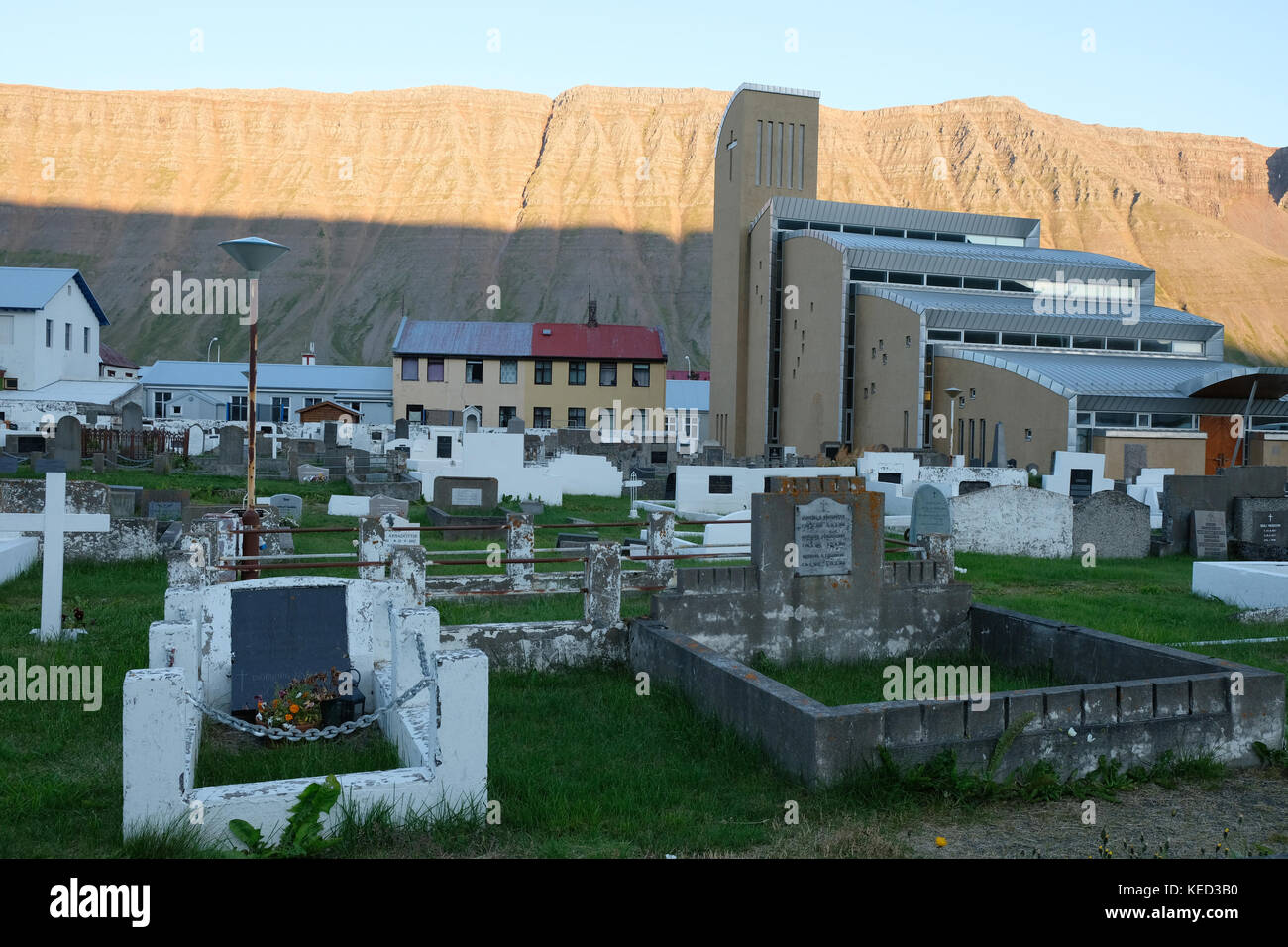Graveyard cemetery and church with mountain backdrop in Isafjordur ...