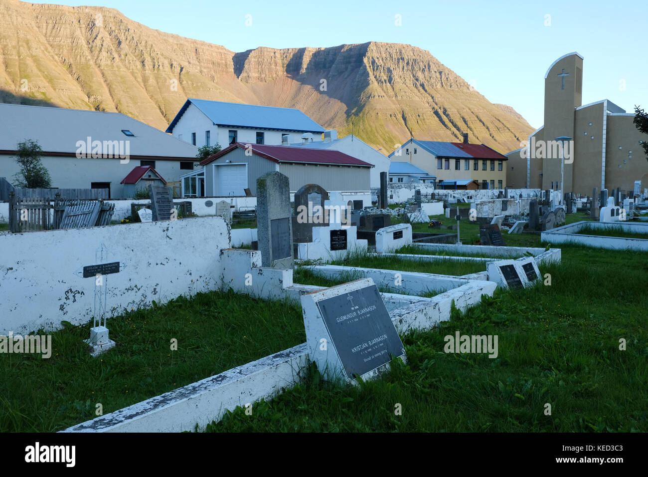 Graveyard cemetery and church with mountain backdrop in Isafjordur ...