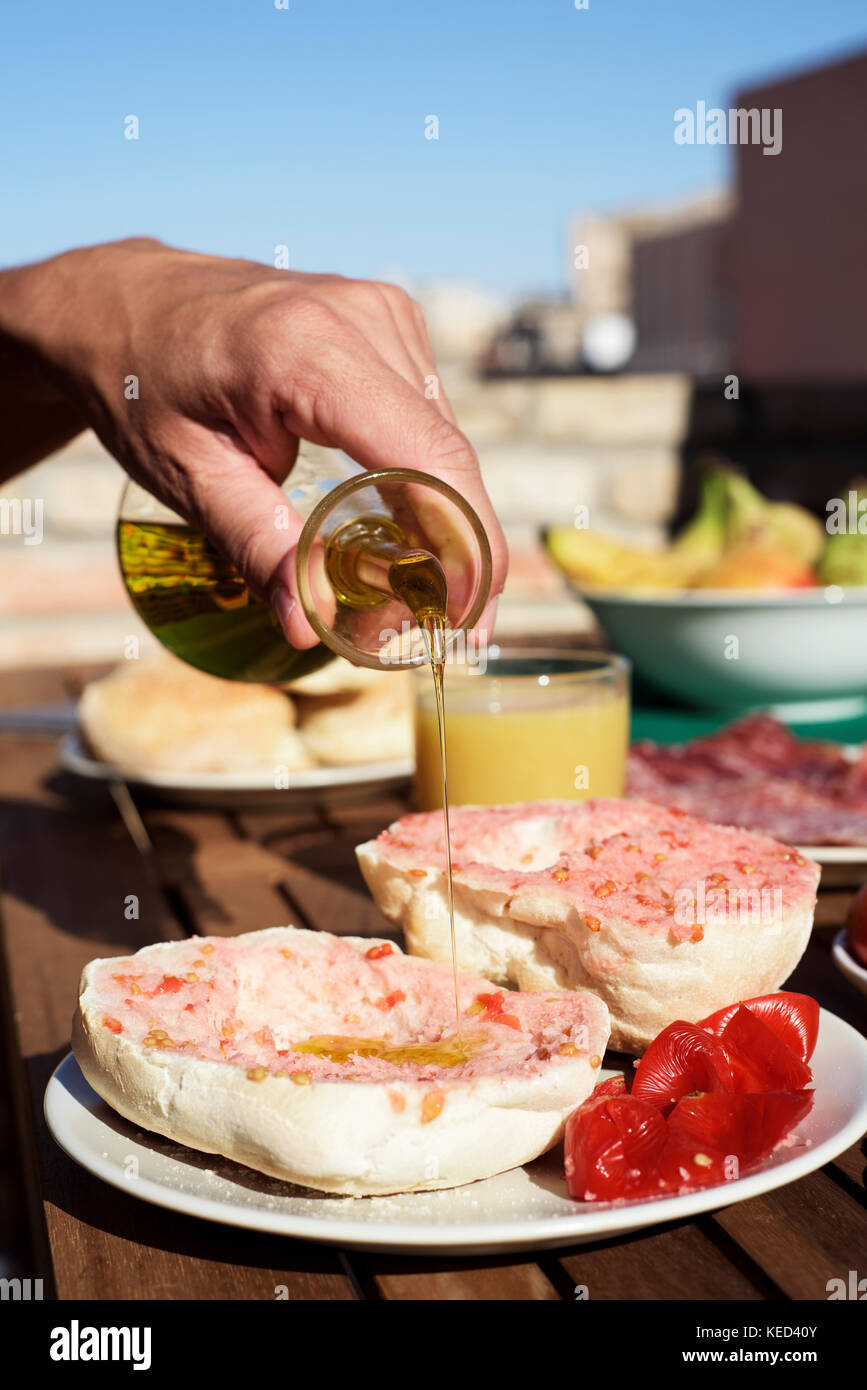 closeup of a man preparing a typical catalan pa amb tomaquet, bread ...