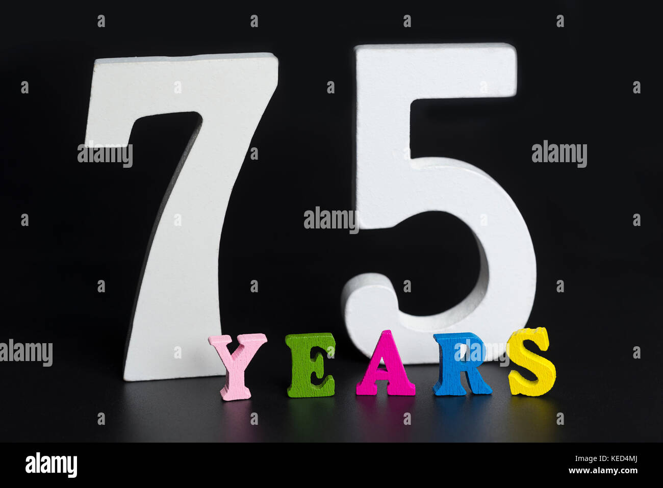 Letters and numbers-seventy-five on black isolated background Stock ...