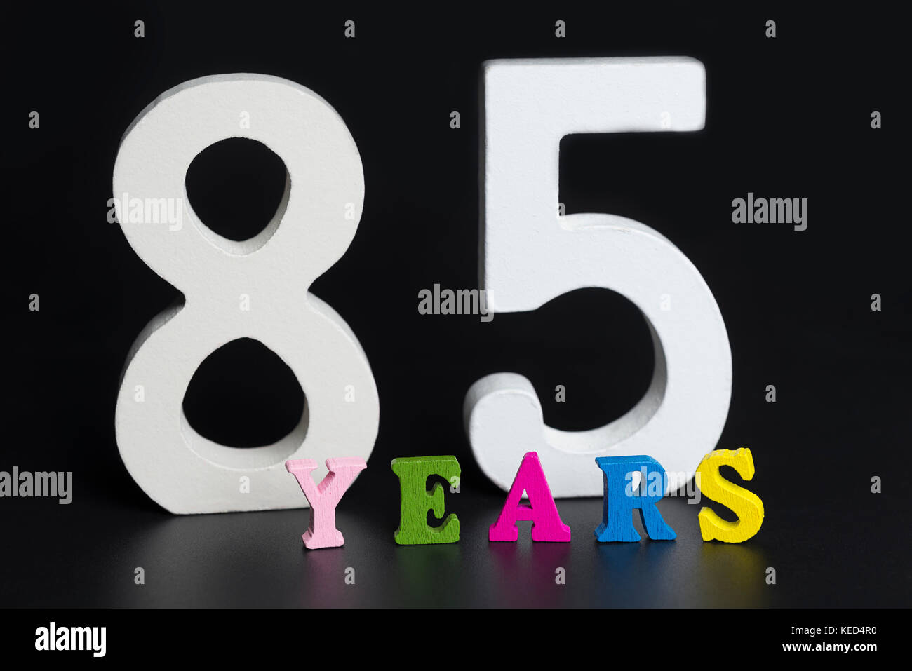 Letters and numbers-eighty-five on black isolated background Stock ...