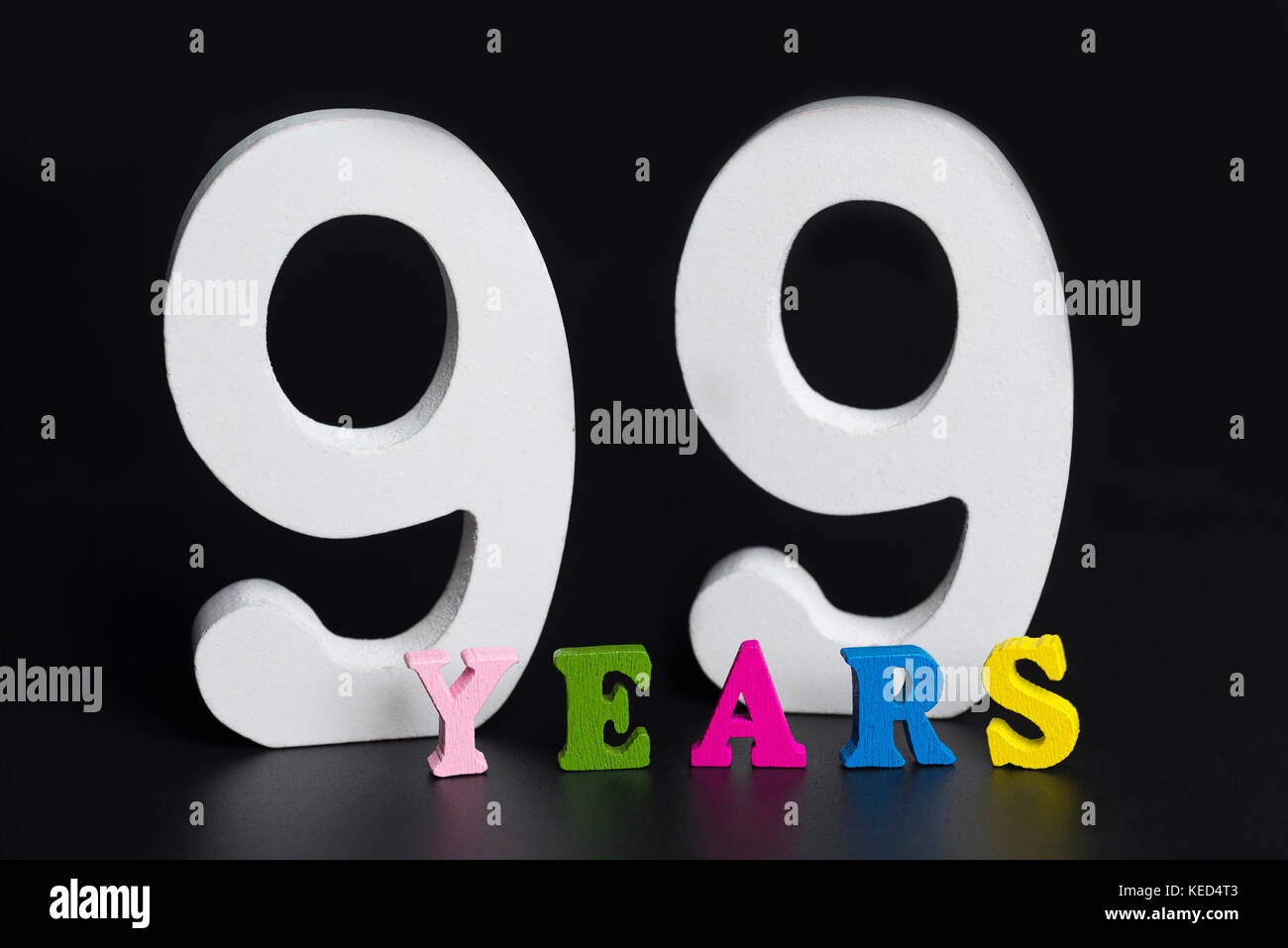 Letters and numbers ninety-nine years on a black isolated background ...