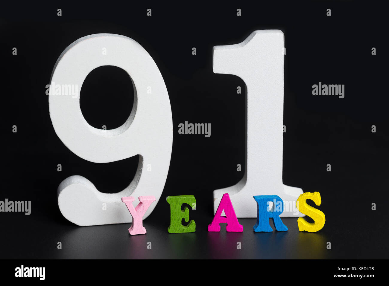 Letters and numbers ninety-one year on black isolated background Stock ...