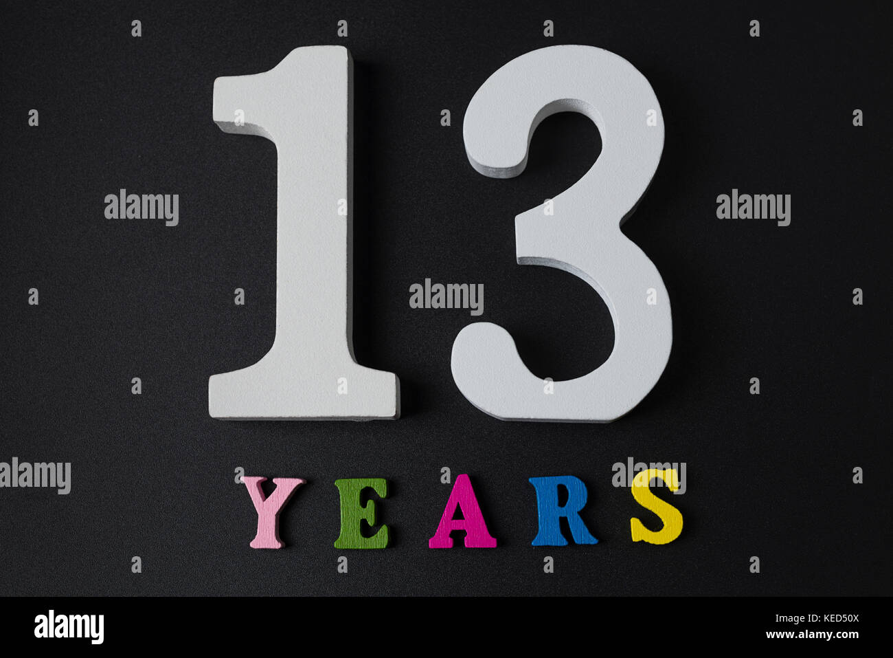Letters and numbers thirteen on black isolated background Stock Photo ...