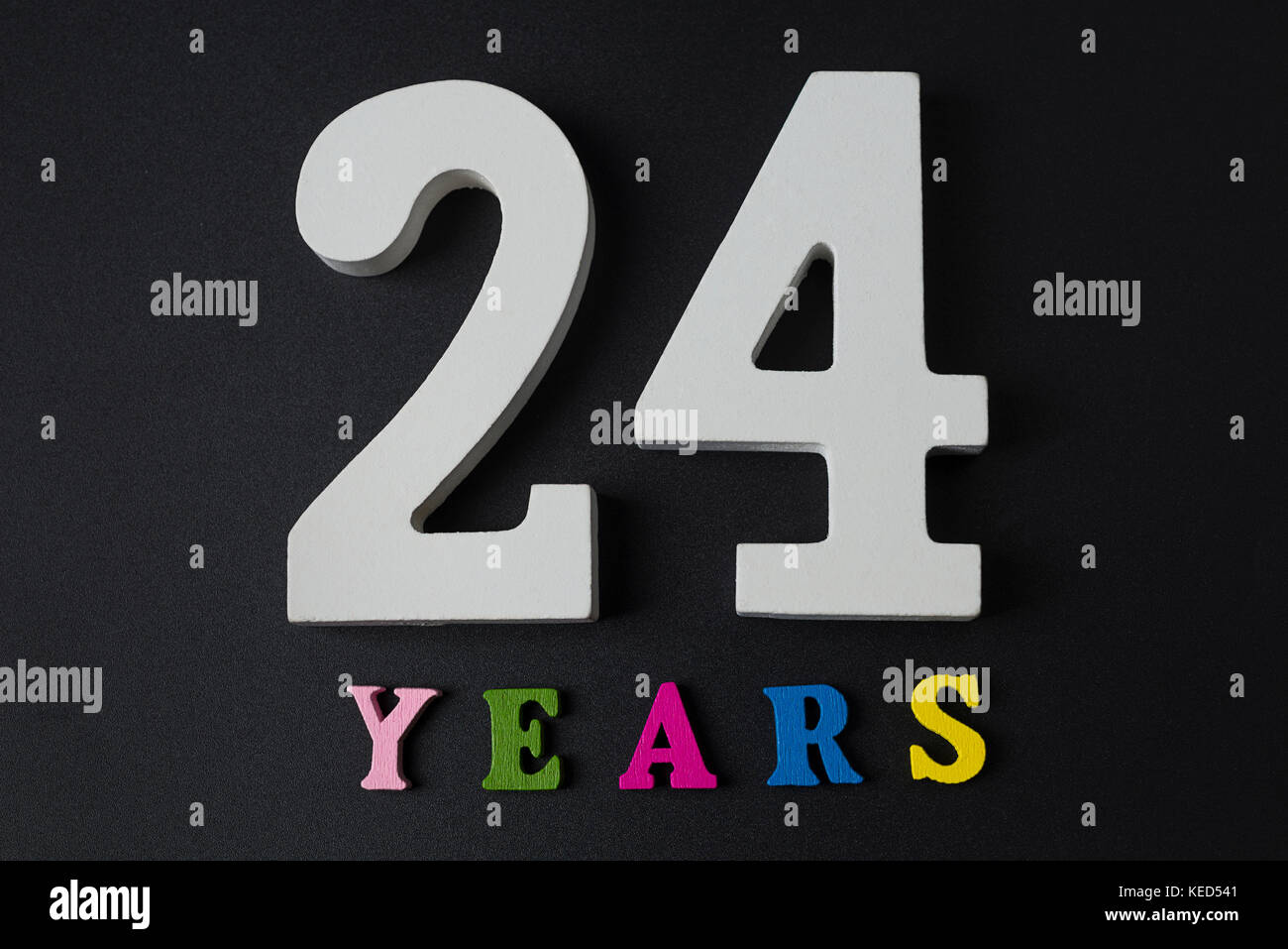 Letters and numbers twenty-four years on a black isolated background ...