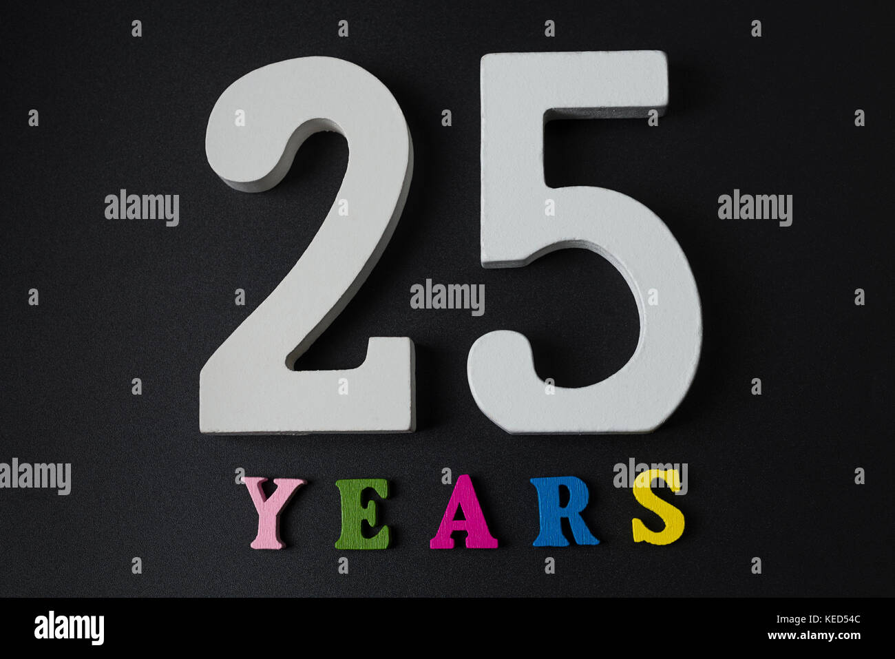 Letters and numbers for twenty-five years on a black isolated ...