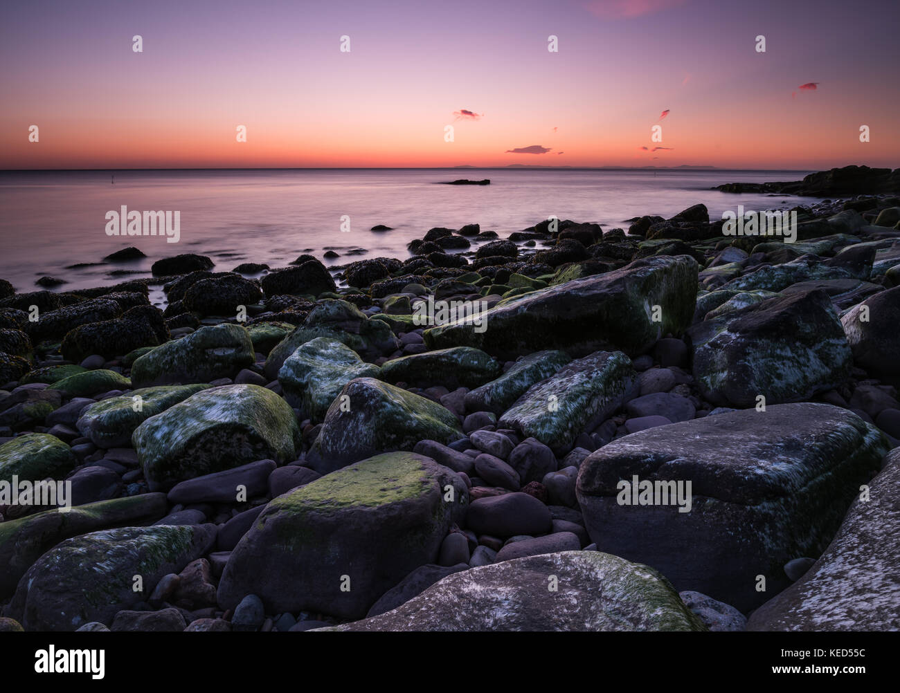 Some stunning colour as dusk falls on the Cumbrian coast Stock Photo ...