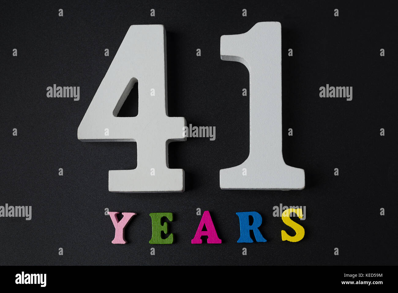 Letters and numbers forty-one year on black isolated background Stock ...