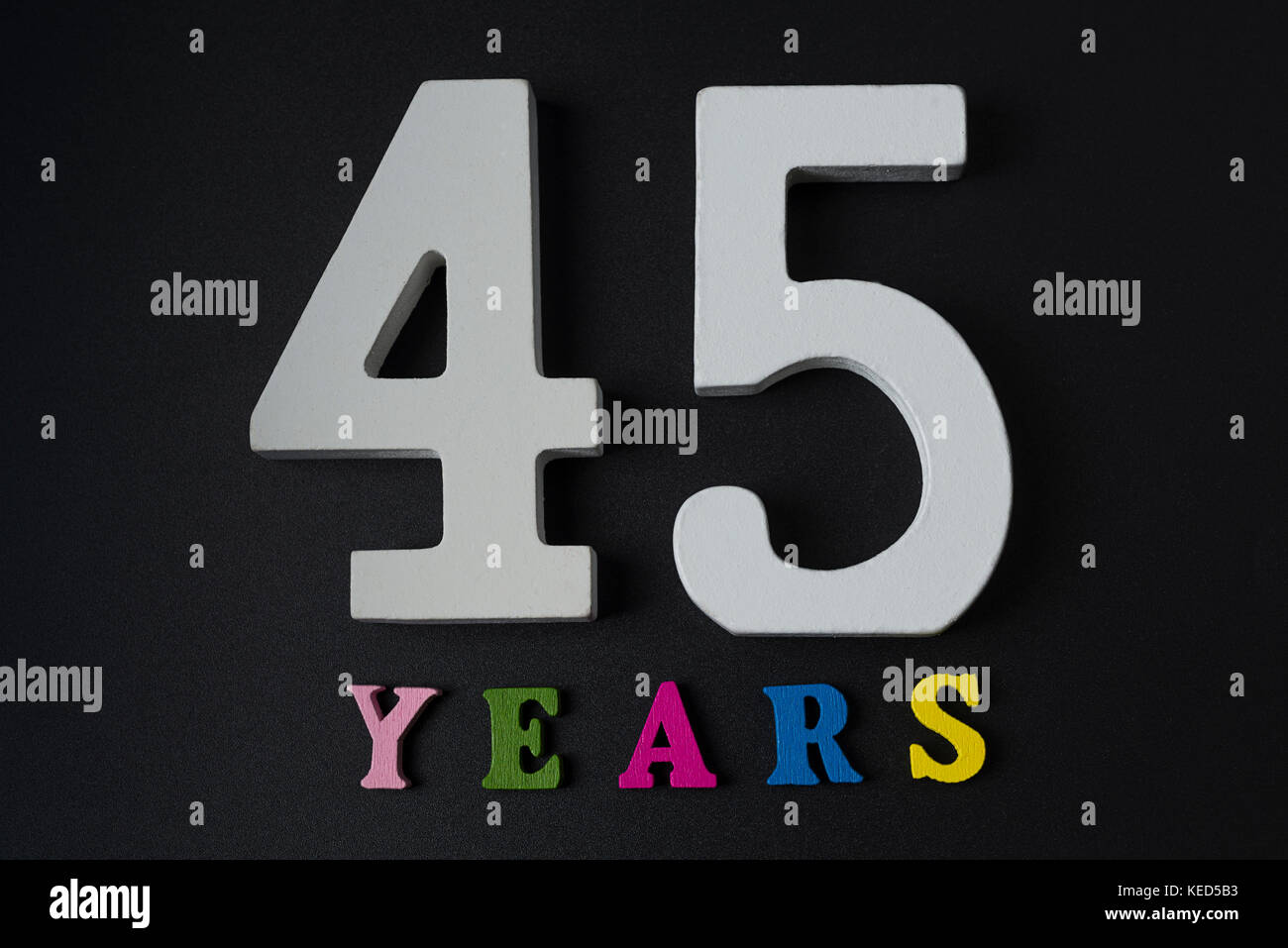 Letters and numbers forty-five years on a black isolated background ...