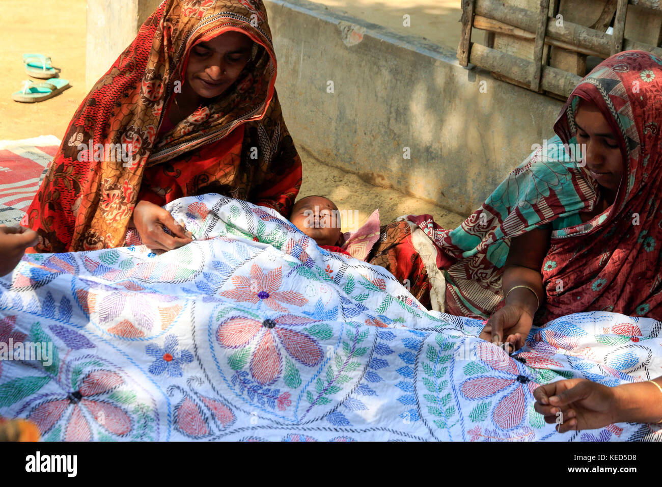 Rural women make Nakshi Kantha, a type of embroidered quilt at a ...