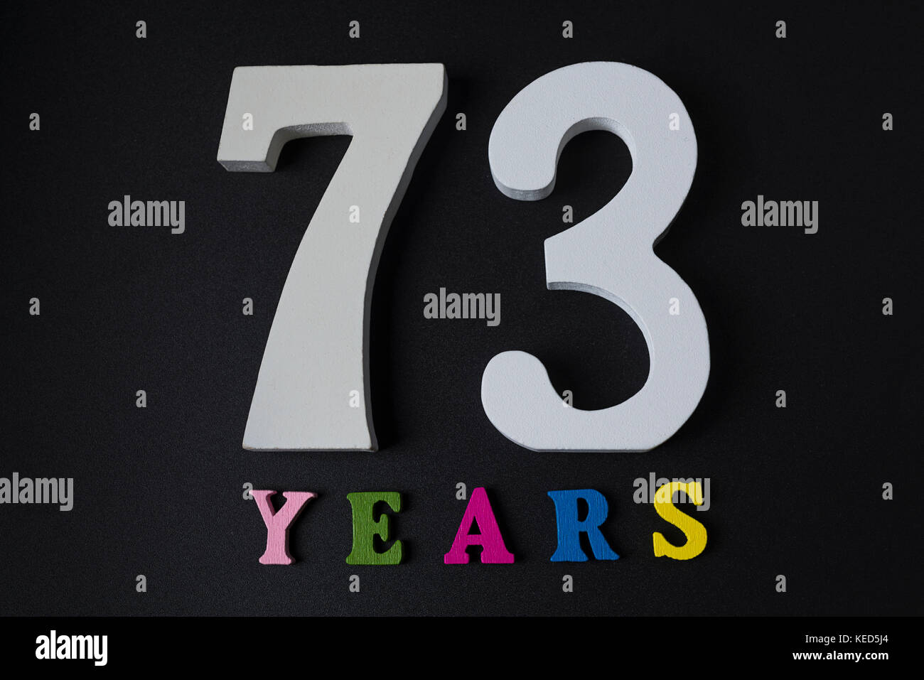 Letters and numbers-seventy-three on black isolated background Stock ...
