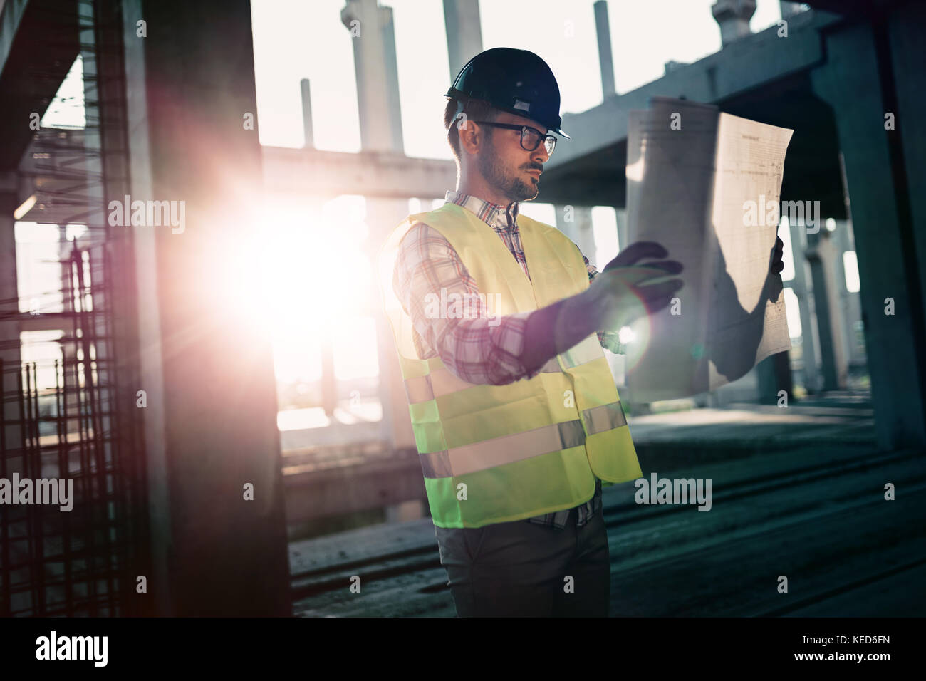 Picture of construction site engineer looking at plan Stock Photo - Alamy