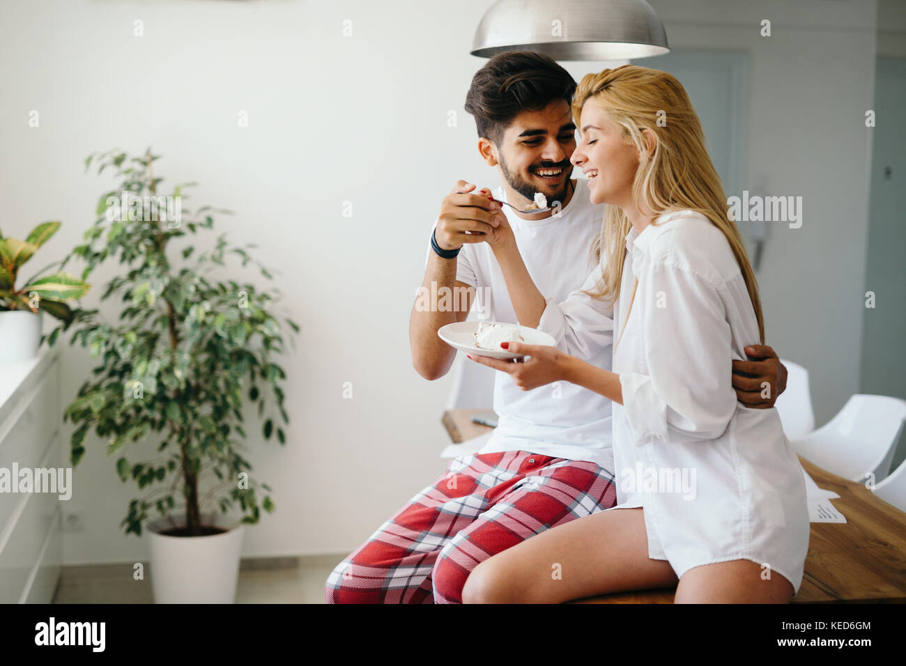 Cute young cheerful couple spending time at home Stock Photo - Alamy