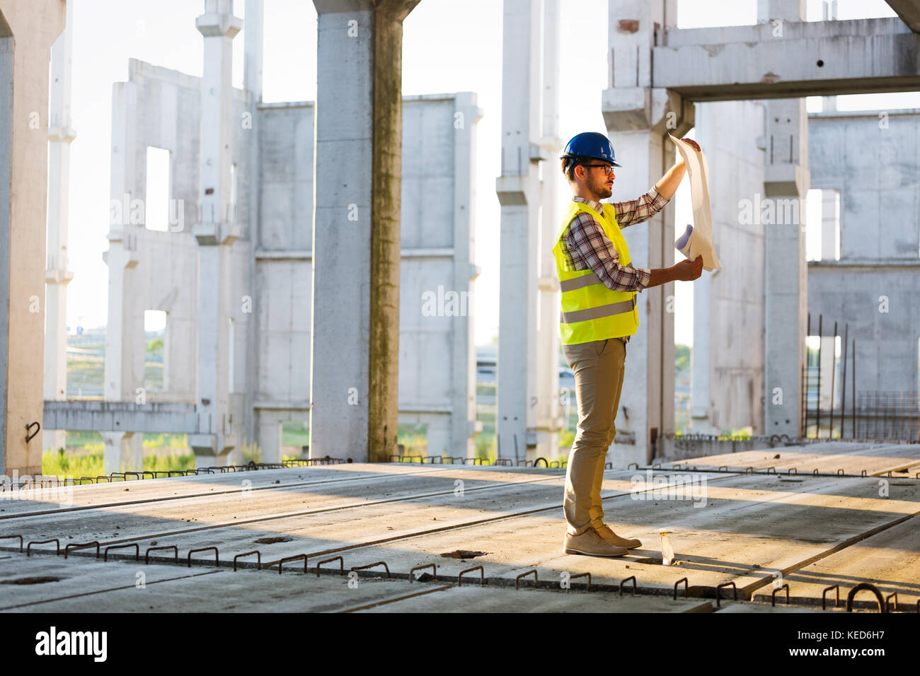 Picture of construction site engineer looking at plan Stock Photo - Alamy