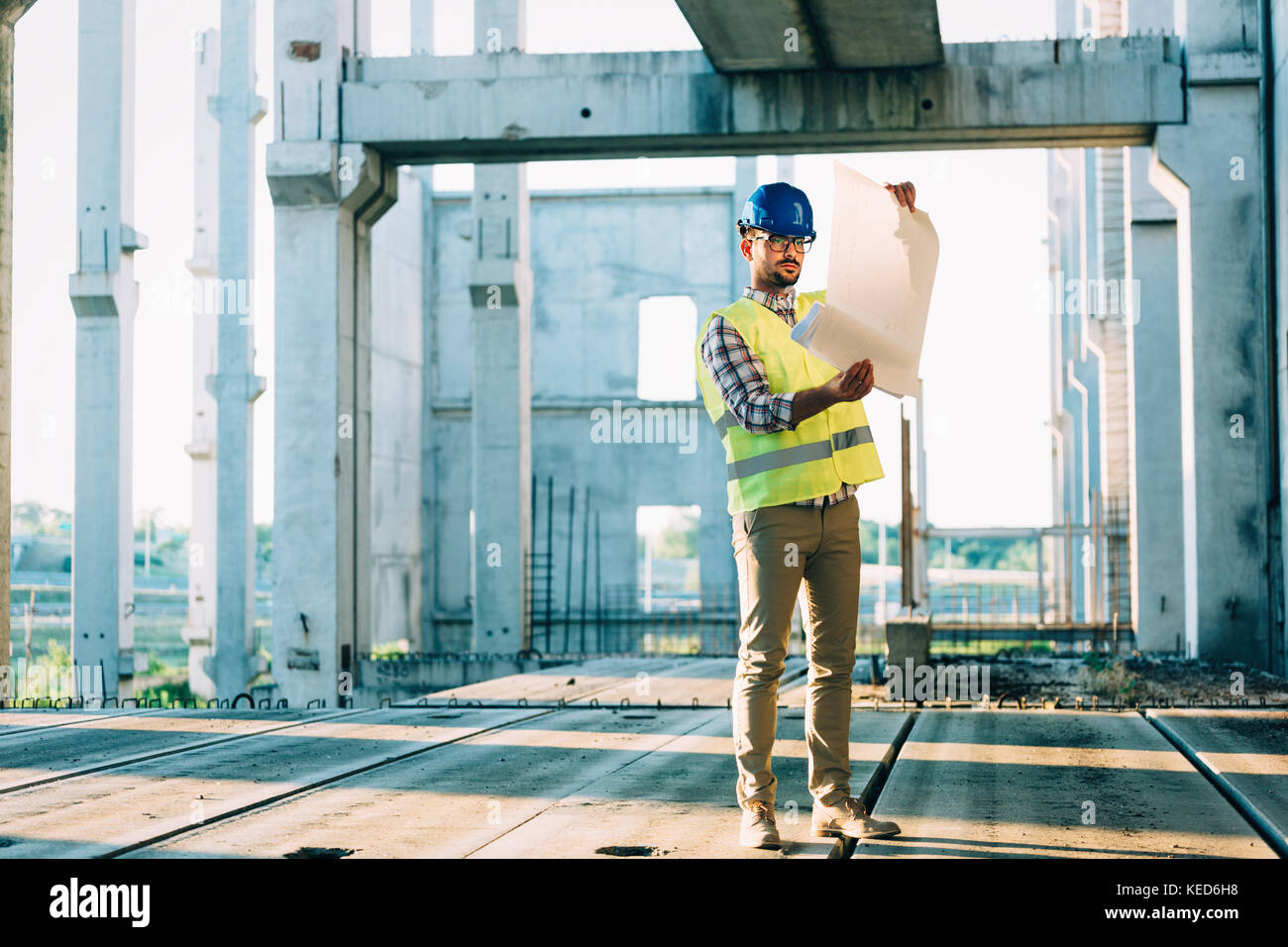 Picture of construction site engineer looking at plan Stock Photo - Alamy