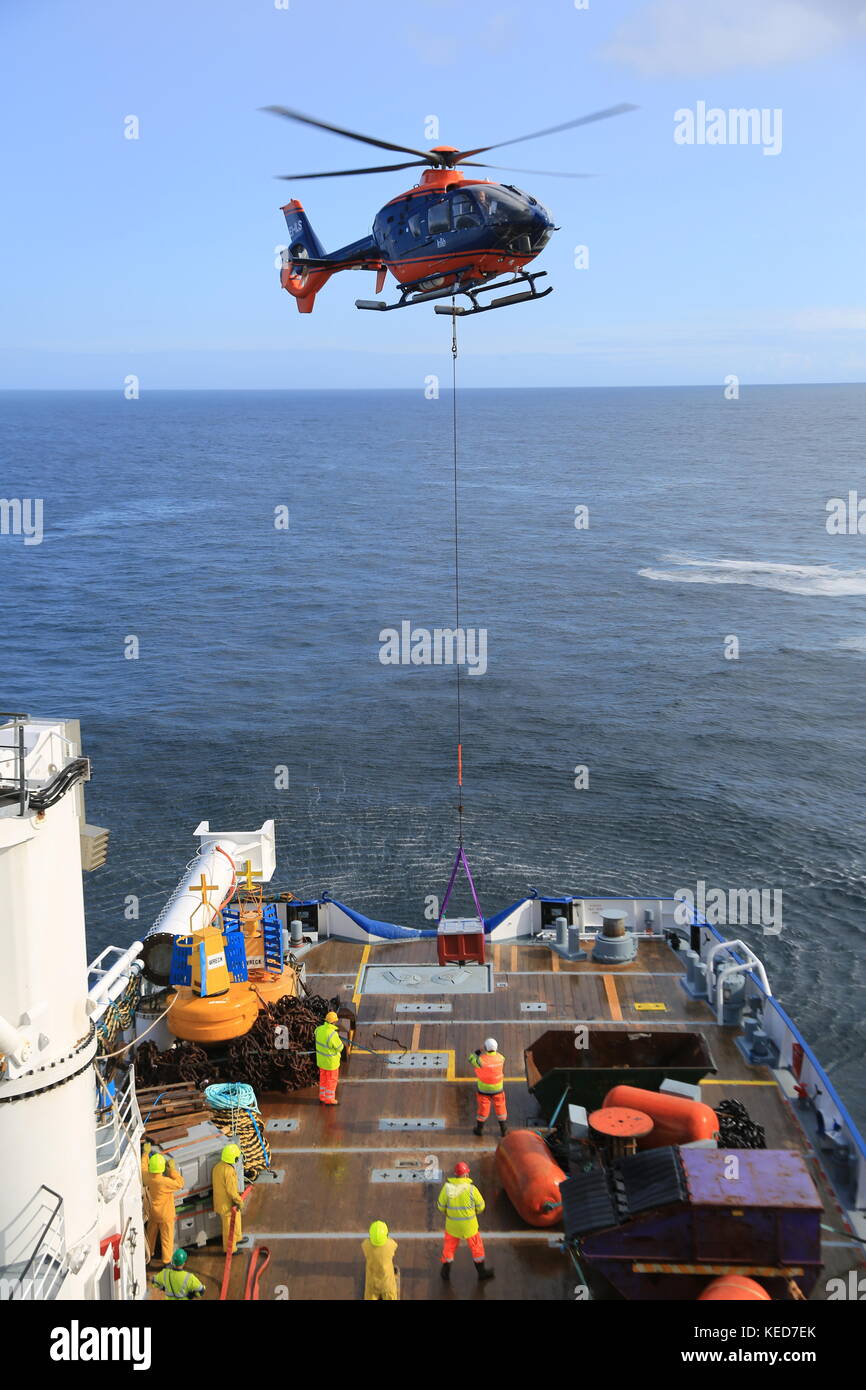Helicopter moving cargo on Large sea vessel Stock Photo - Alamy