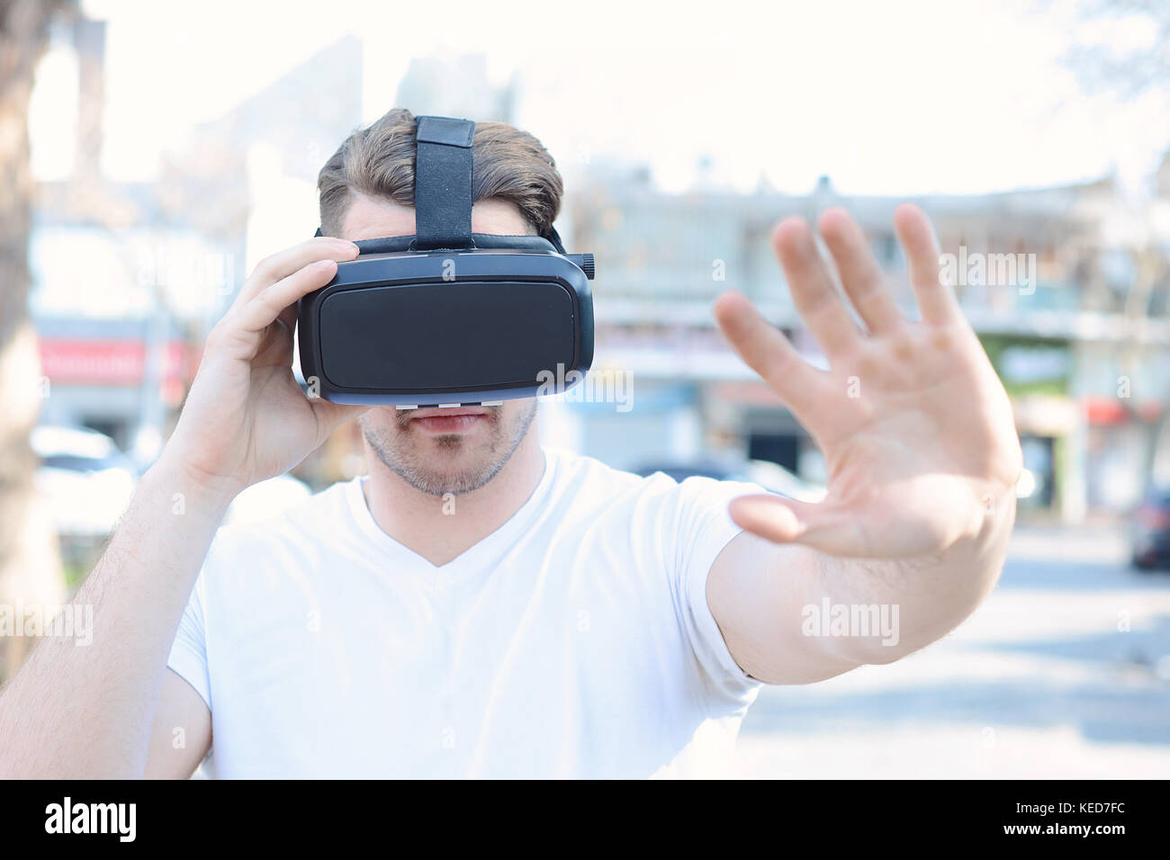 Young man using virtual reality glasses. Outdoors Stock Photo - Alamy