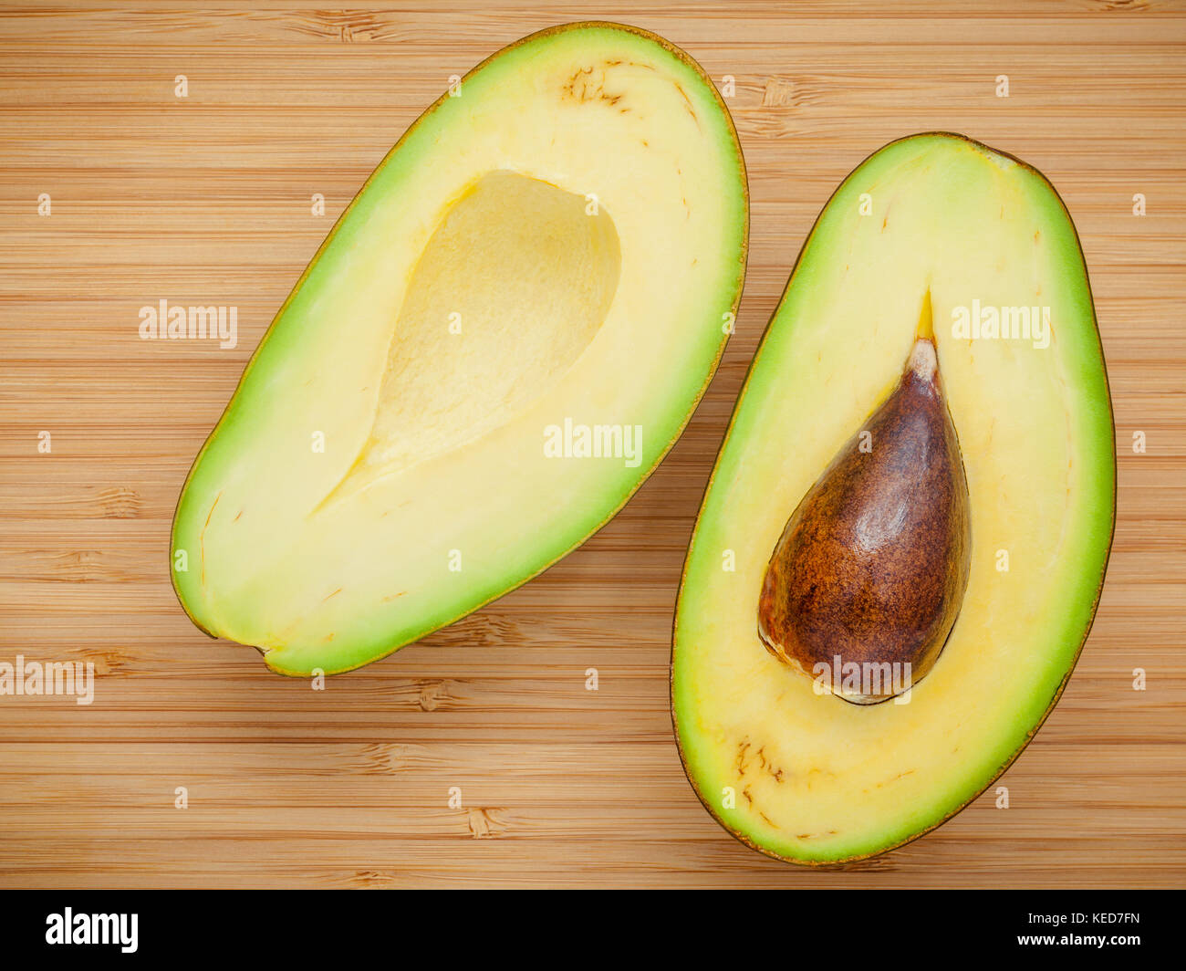 Healthy food concept.Closeup ripe avocado on wooden background. Halved ...