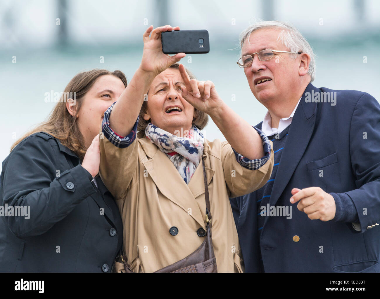 Elderly people struggling with technology while trying to take a family ...