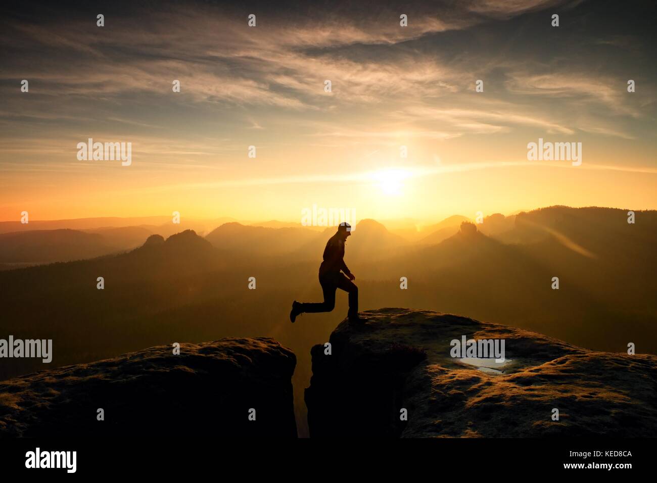 Jumping man. Young man makes jump on colorful sky background in ...