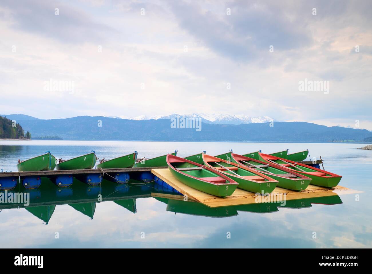 Blue Alps lake with Rental rowing boats in marina. Wharf for trip ships ...