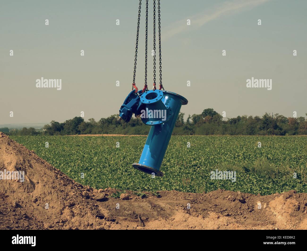 Crane lifting tube and gate valve within water pipeline building. New ...