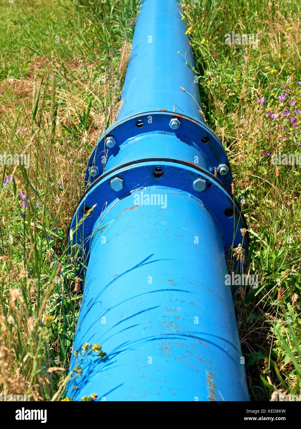 Repaired big drink water pipes joined with new blue flanges and silver ...