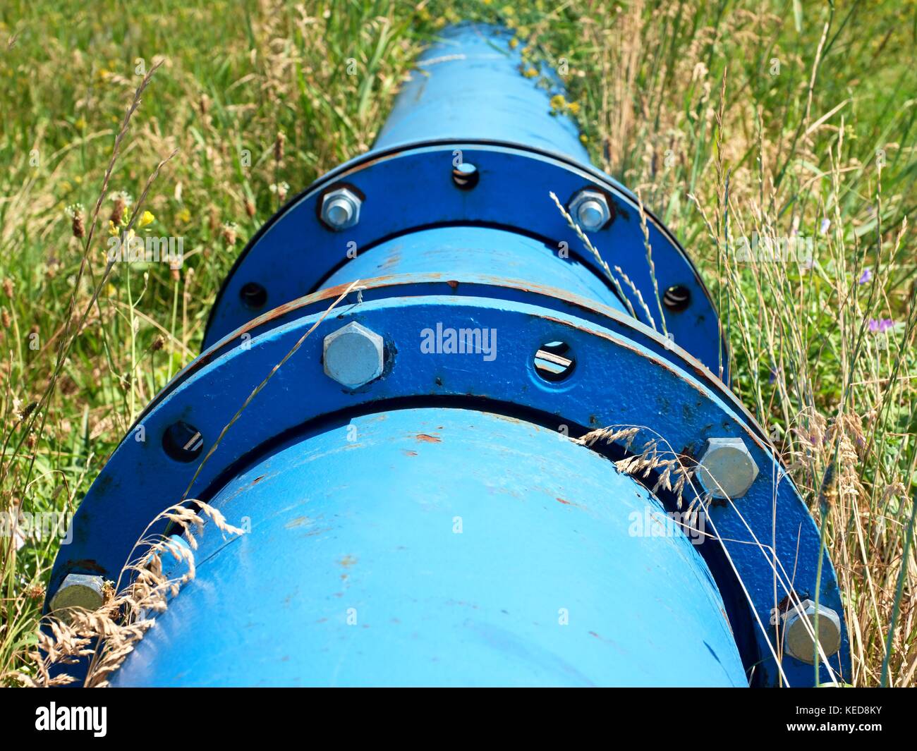 Repaired big drink water pipes joined with new blue flanges and silver ...