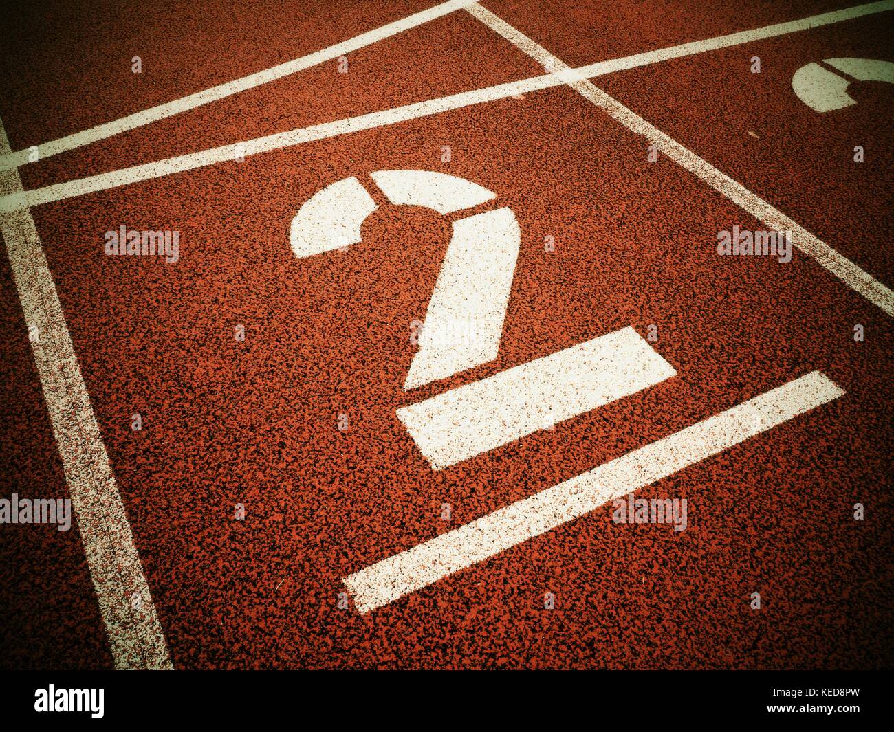 Number two. Big white track number on red rubber racetrack. Gentle ...