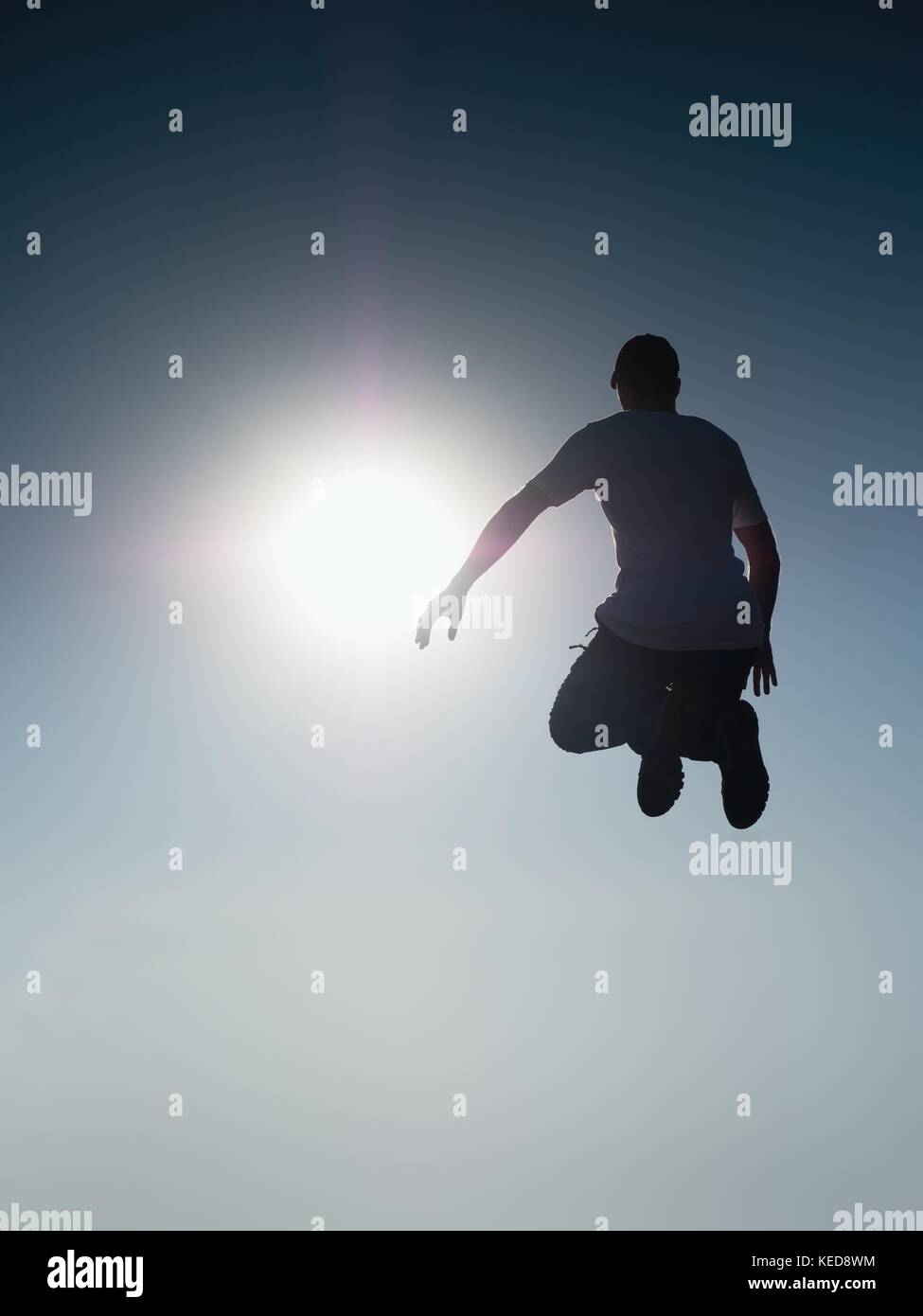 Man fly in air. Blue Toned effect. Man falling down with raised arms ...