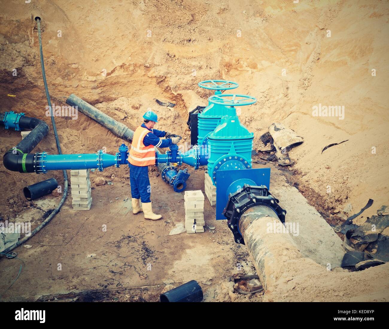 Worker works underground for reconstrucion of drink water system ...