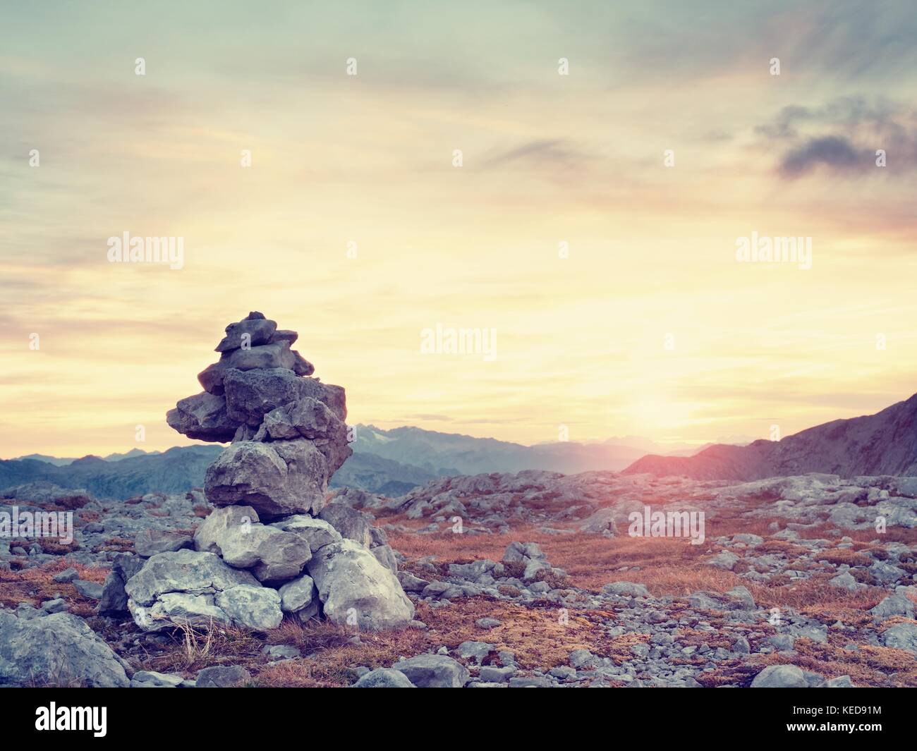 Sharp stones stacked at trail run. Heavy pebbles stack on dry grass on ...