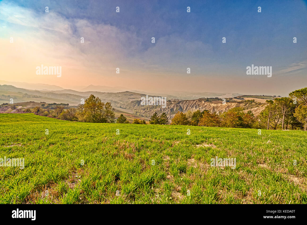 landscape of badlands and green hill with trees in autumn sunny day ...