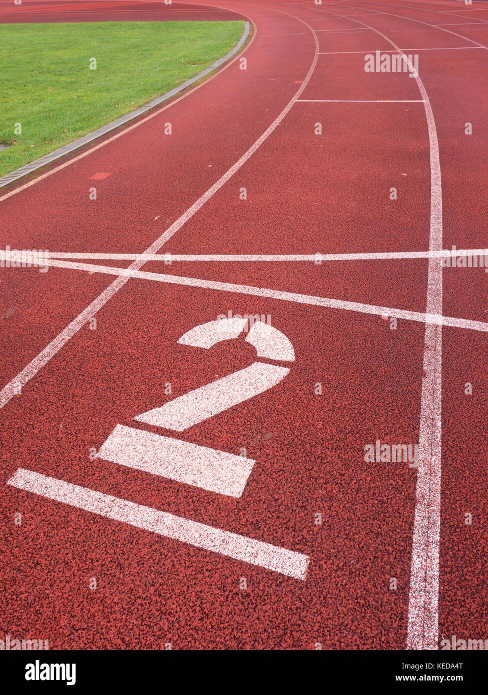 Number two. Big white track number on red rubber racetrack. Gentle ...