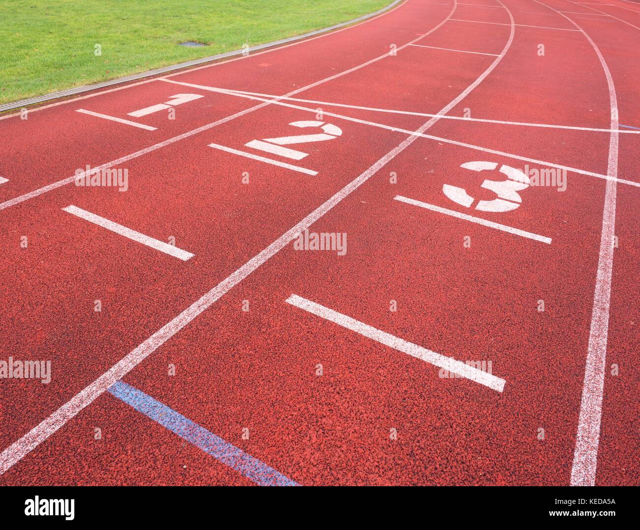 White track number on red rubber racetrack, texture of running ...