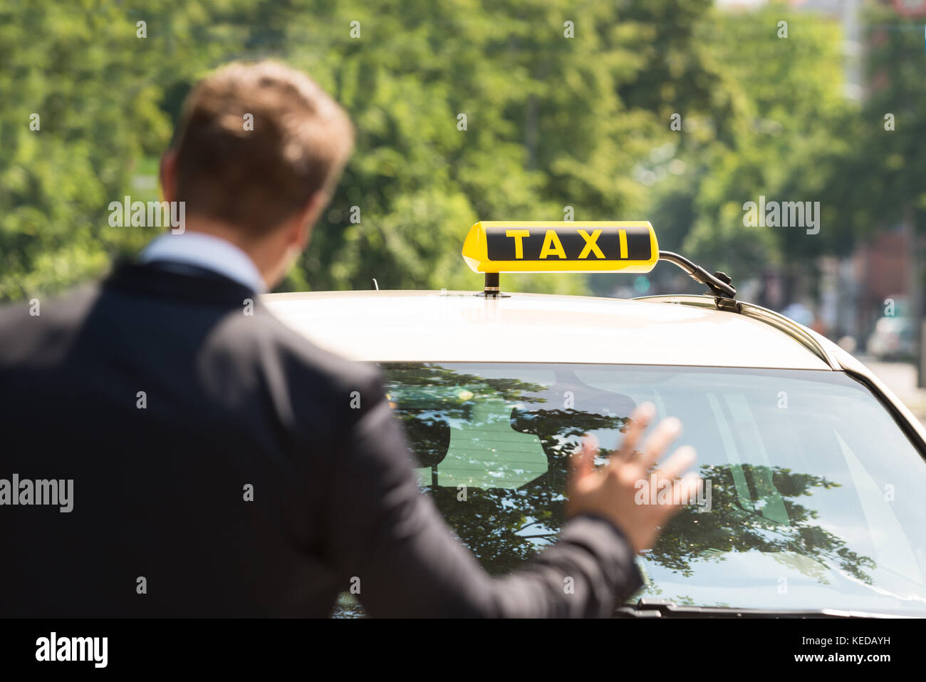 Close-up Photo Of A Businessman Calling Taxi Stock Photo - Alamy