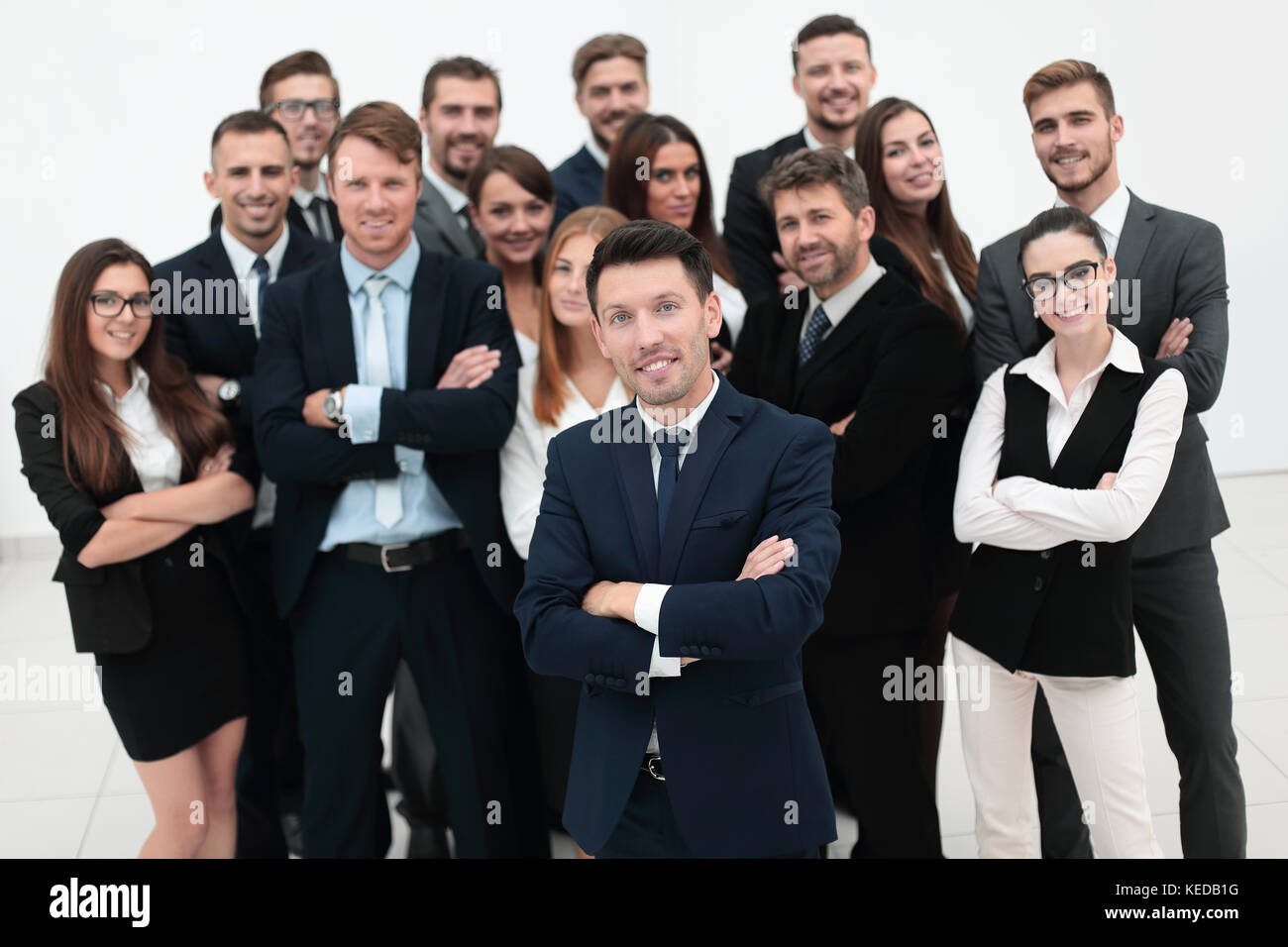 leader standing in front of a large business team Stock Photo - Alamy