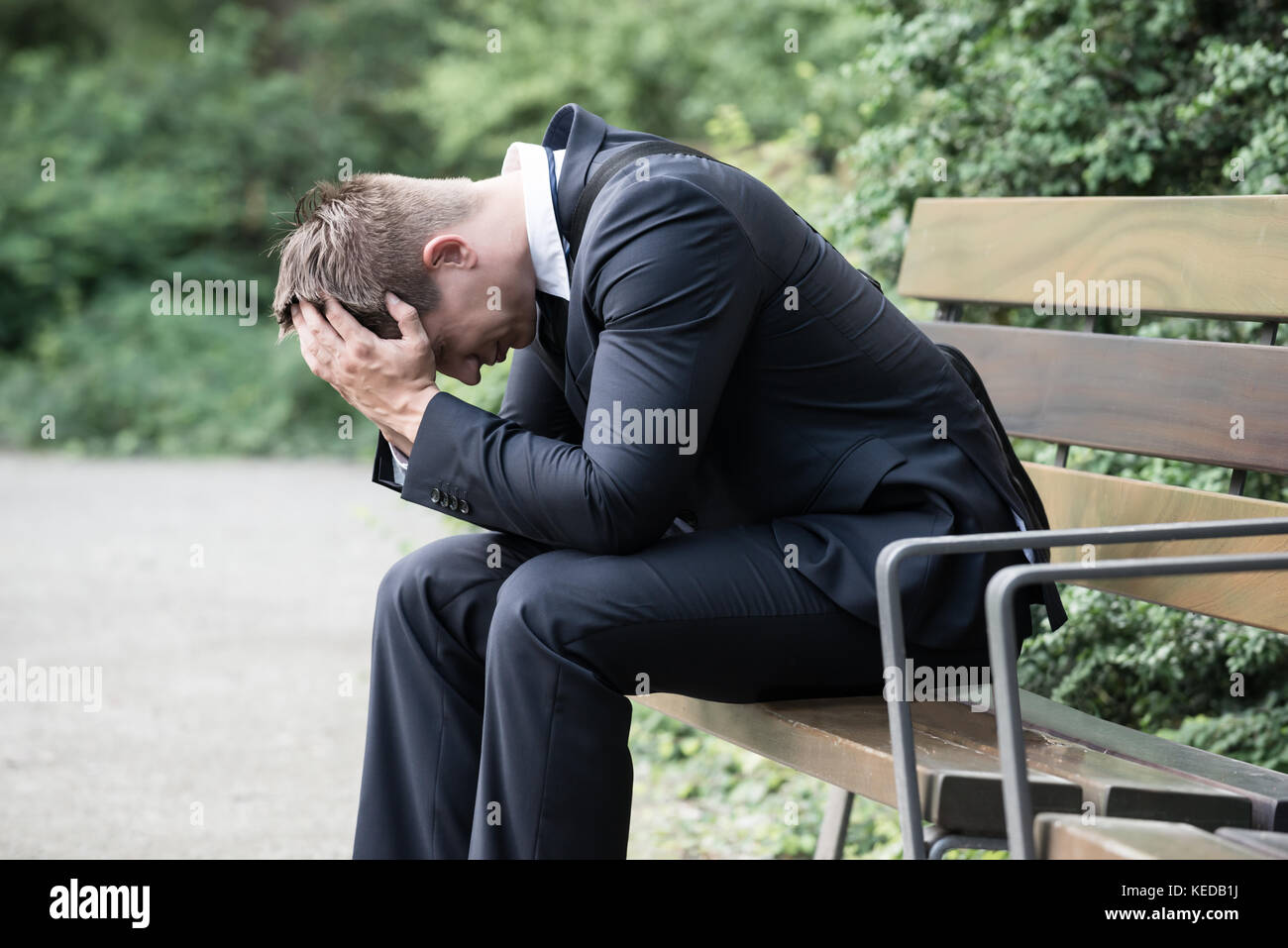 Sad man sitting on bench hi-res stock photography and images - Alamy