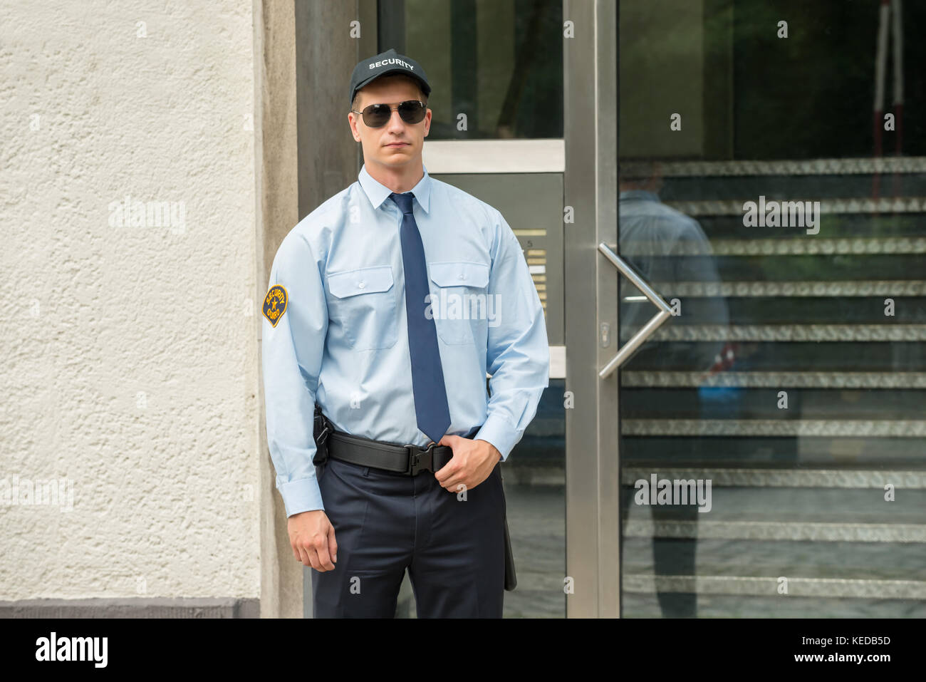 Portrait Of Young Male Security Guard Standing At The Entrance Stock ...