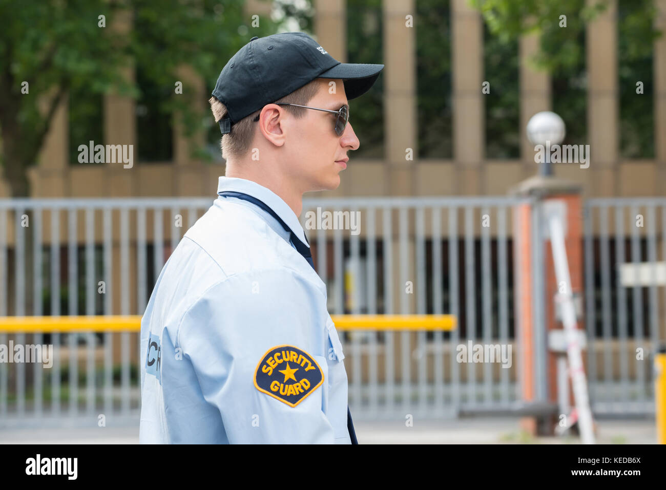 Side View Of A Young Male Security Guard In Uniform Stock Photo - Alamy