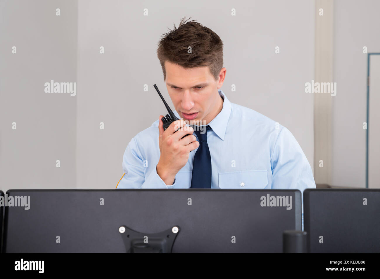 Security guard talking on walkie talkie hi-res stock photography and ...