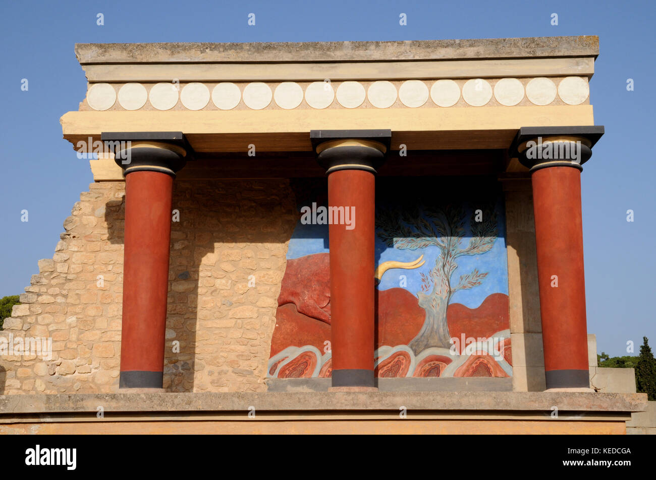 Restored columns and fresco at the Minoan Palace of Knossos in Crete ...