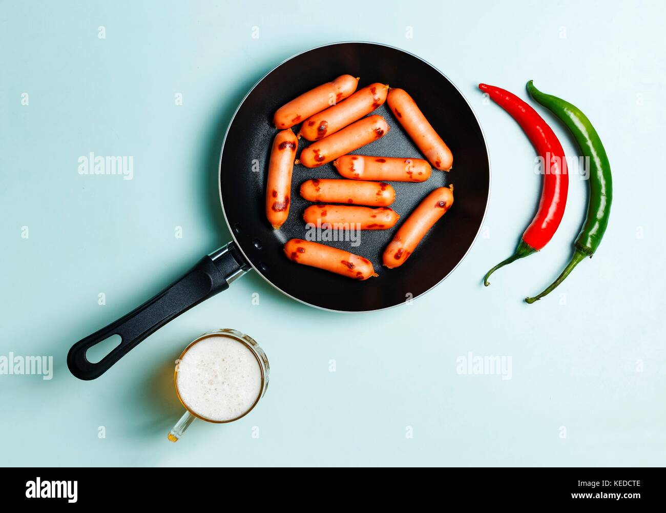Beer and sausages fried in a frying pan, a top view, Closeup, blue ...