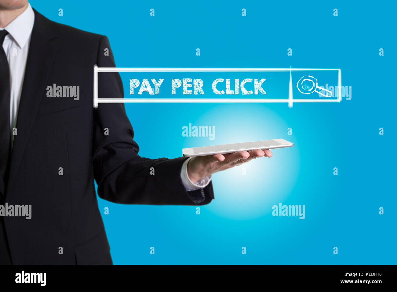 pay per click, young man holding a tablet computer Stock Photo - Alamy