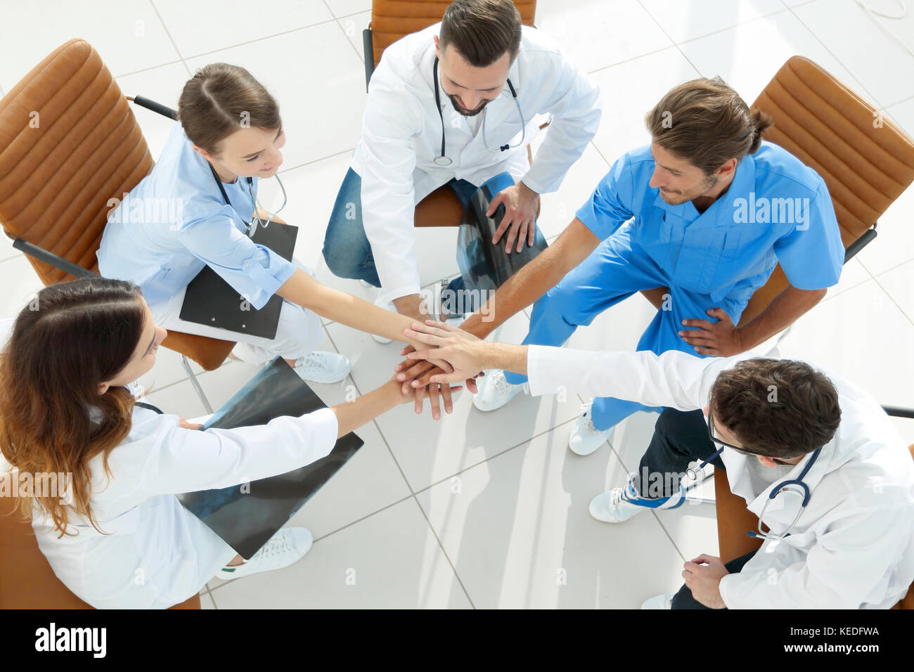 medical staff hands clasped together,sitting at a Desk Stock Photo - Alamy