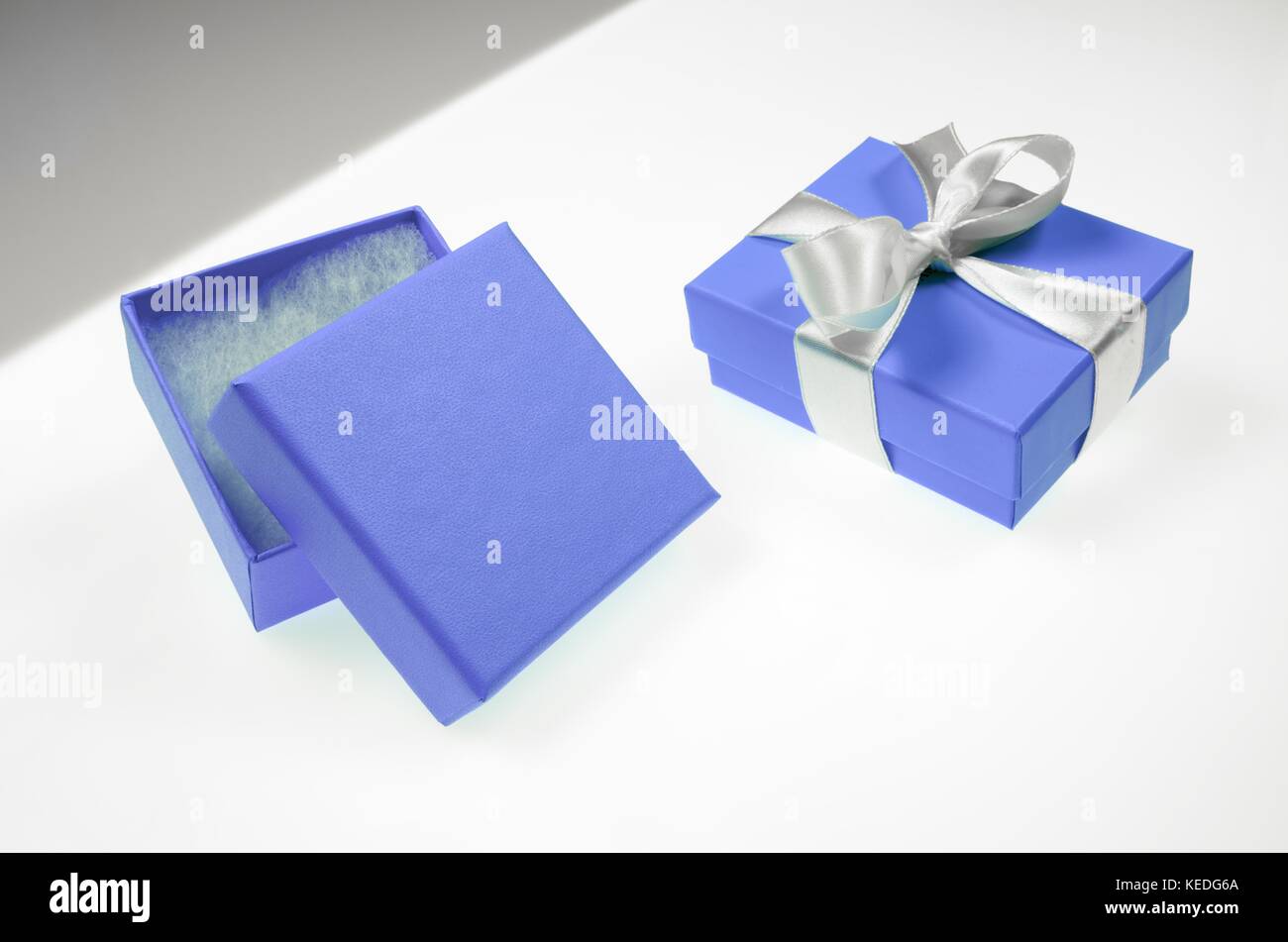 two small blue box tied with a white ribbon Stock Photo - Alamy