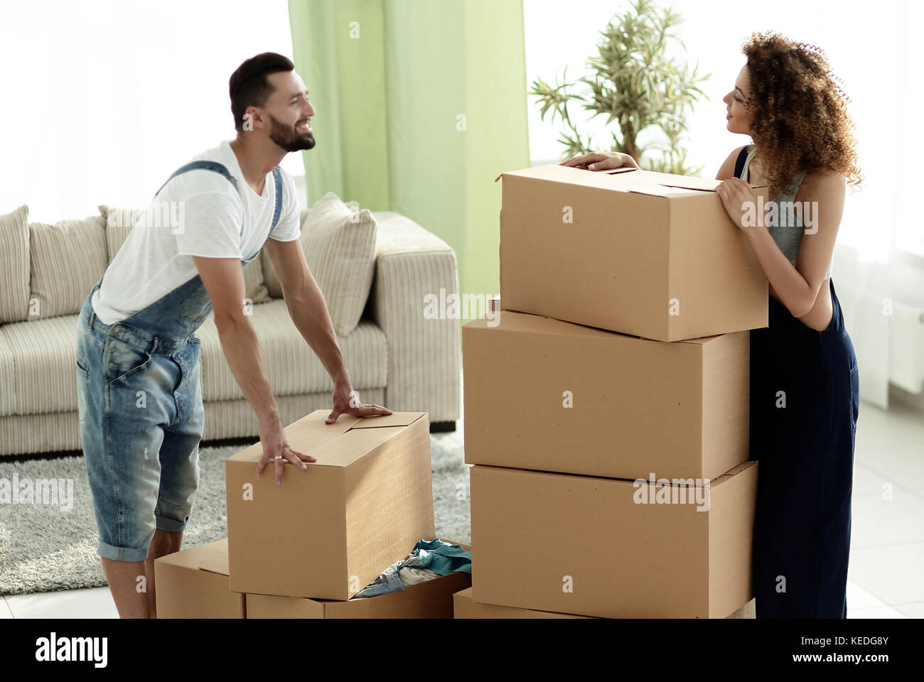 Happy and young couple looking at boxes Stock Photo - Alamy