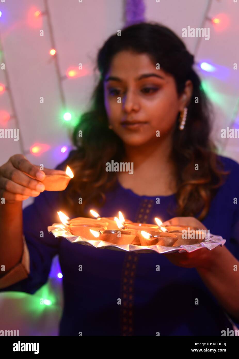 Allahabad: An indian Girl light oil lamps during deepavali festival celebration in Allahabad ...