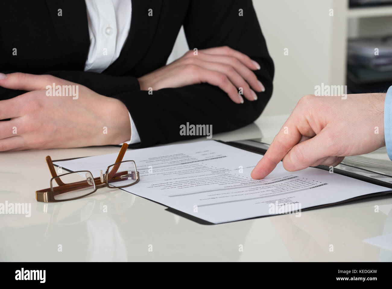 Close-up Of Businessperson Pointing On Document At Desk Stock Photo - Alamy